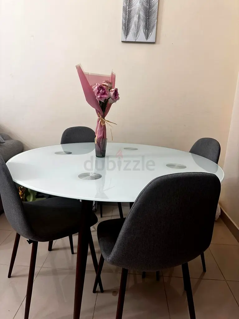 Elegant Round Glass Dining Table with Stylish Chairs | dubizzle Abu Dhabi