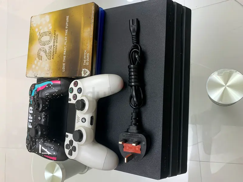 PS4 pro + controllers + games | dubizzle Ajman