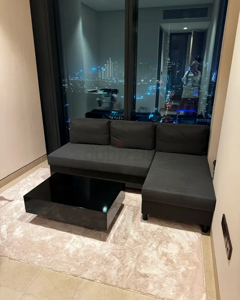 Grey Sofa Bed with coffee table and carpet | dubizzle UAE