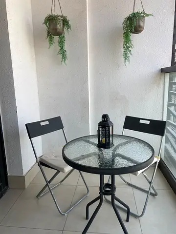 Classifieds: Glass-top bistro table with two folding chairs - compact ...