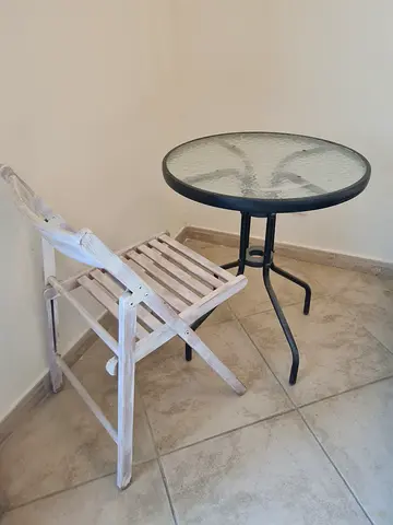 Classifieds: Small Glass Top Outdoor Table and Folding Wooden Chair ...